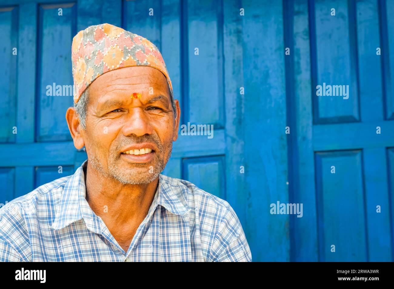 Beni, Nepal, circa May 2012: Old man with colourful cap on head and red ...