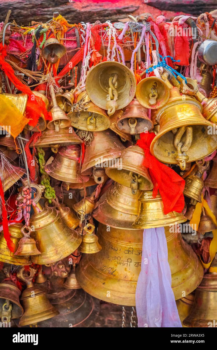 Photo of many golden bells with red cloth near Pathivara Devi Temple in ...