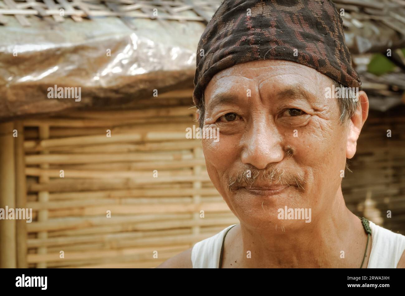 Damak, Nepal, circa May 2012: Native man with brown cap on his head and ...