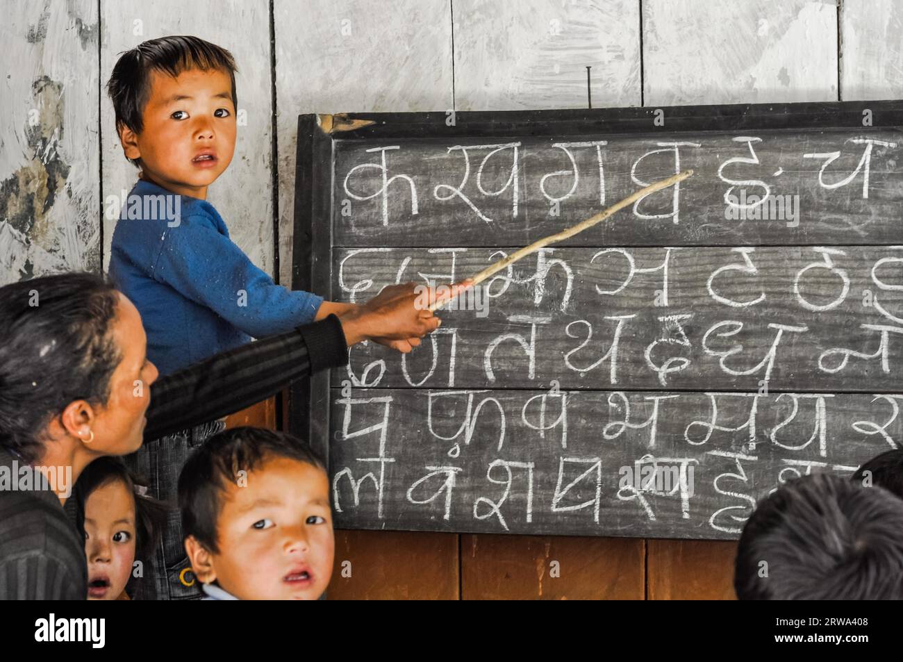 Kanchenjunga Trek, Nepal, circa May 2012: Woman teaches children ...
