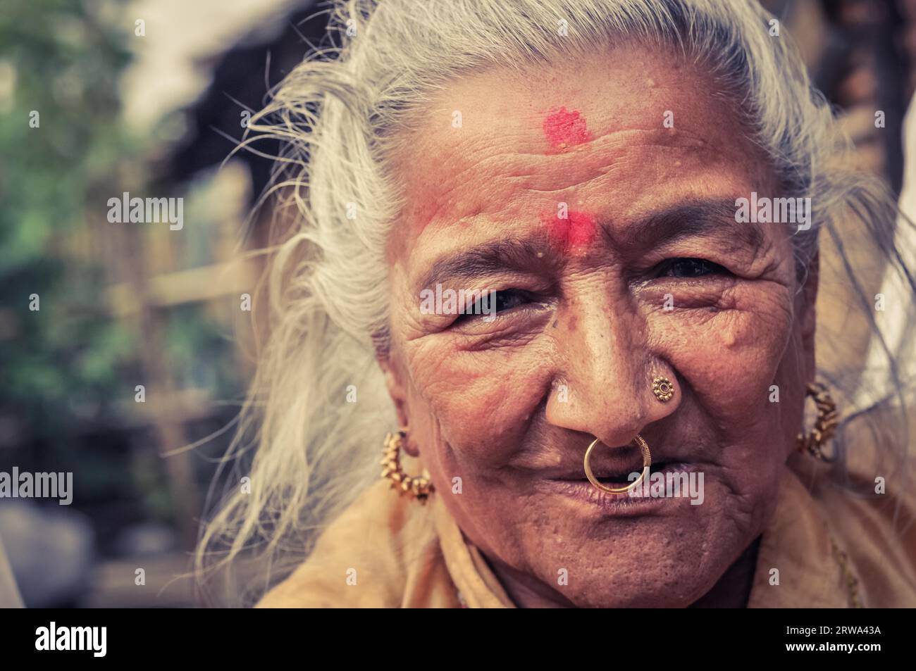 Damak, Nepal, circa May 2012: Photo of old woman with red dots on her ...