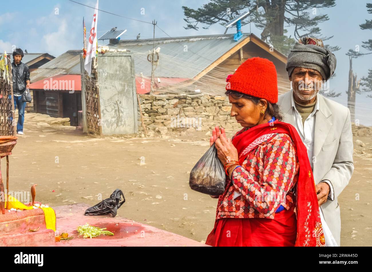Pathivara Devi, Nepal, circa May 2012: Woman in red clothes holds black ...