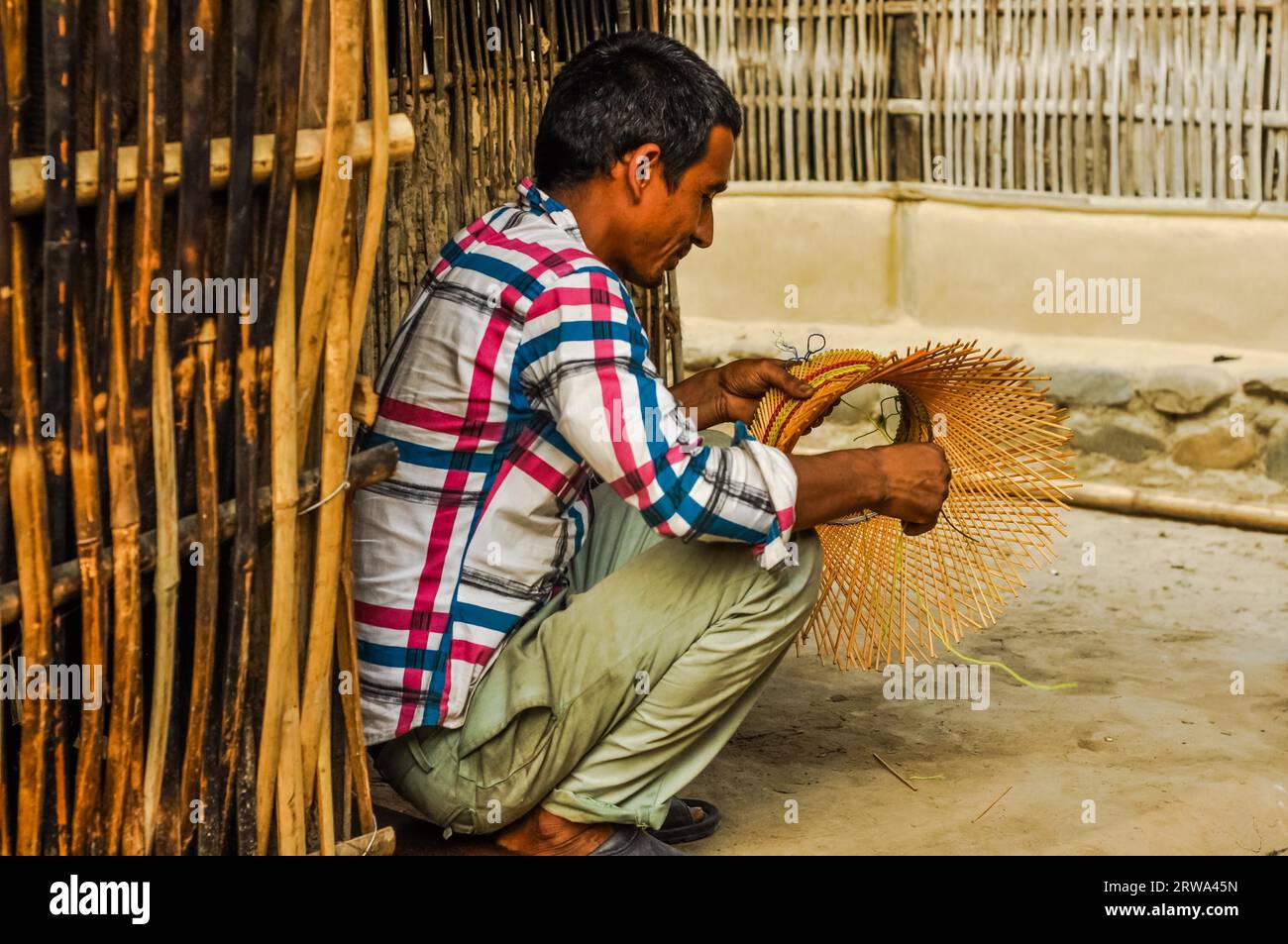 Damak, Nepal, circa May 2012: Native man in checked blue and red shirt ...