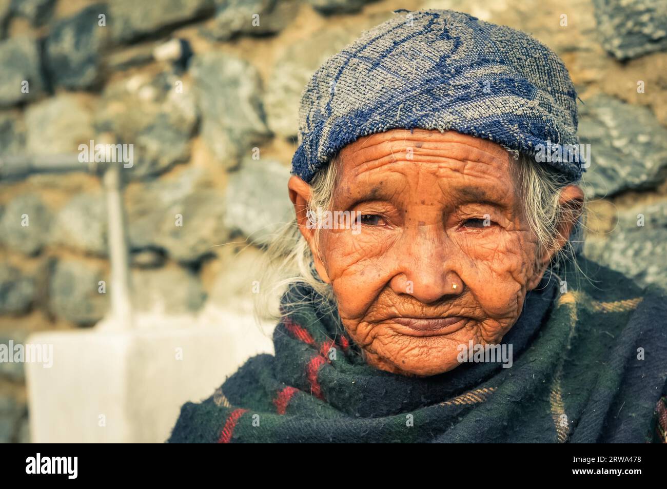 Beni, Nepal, circa May 2012: Old native woman with wrinkles on face and ...