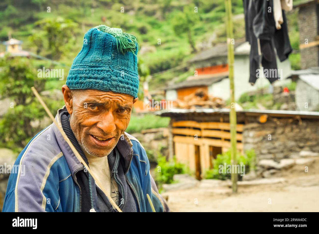 Beni, Nepal, circa May 2012: Old man with blue knitted cap on head has ...