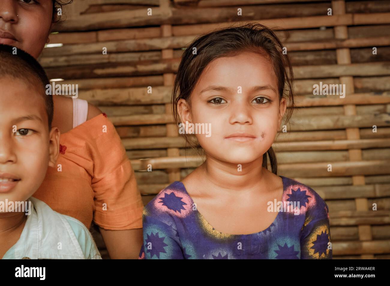 Damak, Nepal, circa May 2012: Young girl with brown hair wears blue ...