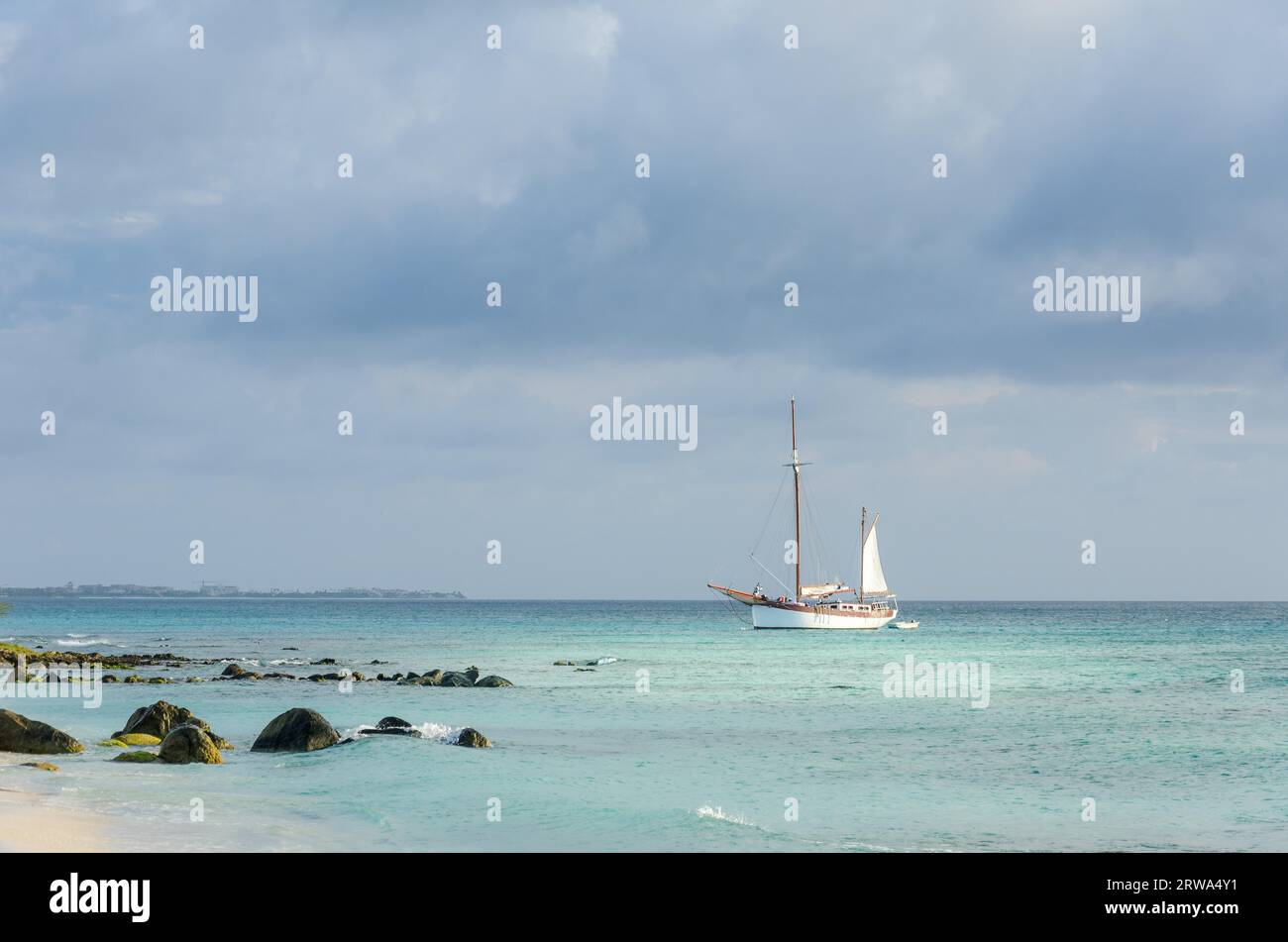 Picture showing a big sailboat on sea navigating towards the beach. The ...
