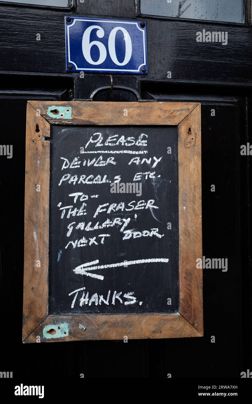 Deliver parcels next door sign hi-res stock photography and images - Alamy