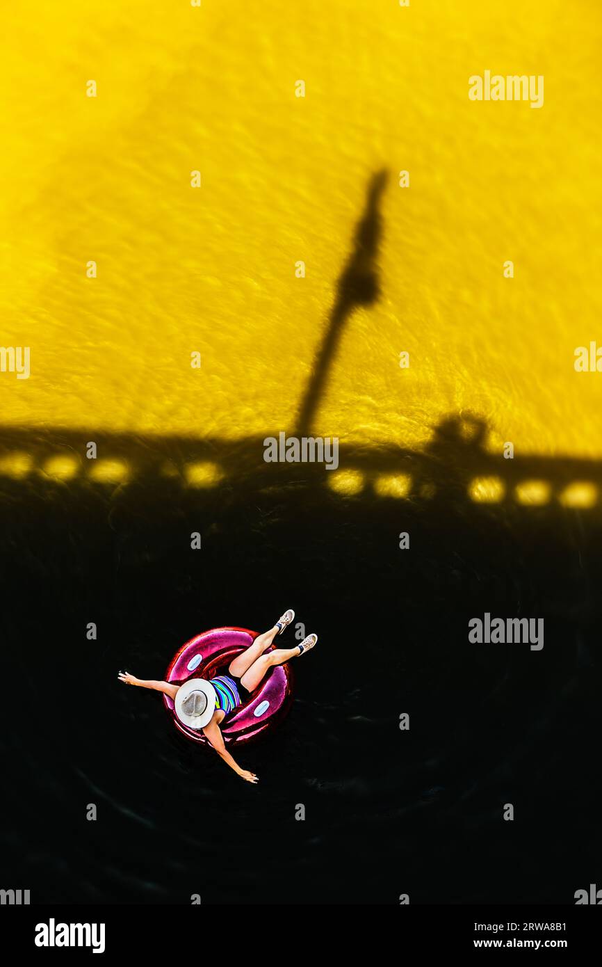 A woman floating in an inner tube Stock Photo - Alamy