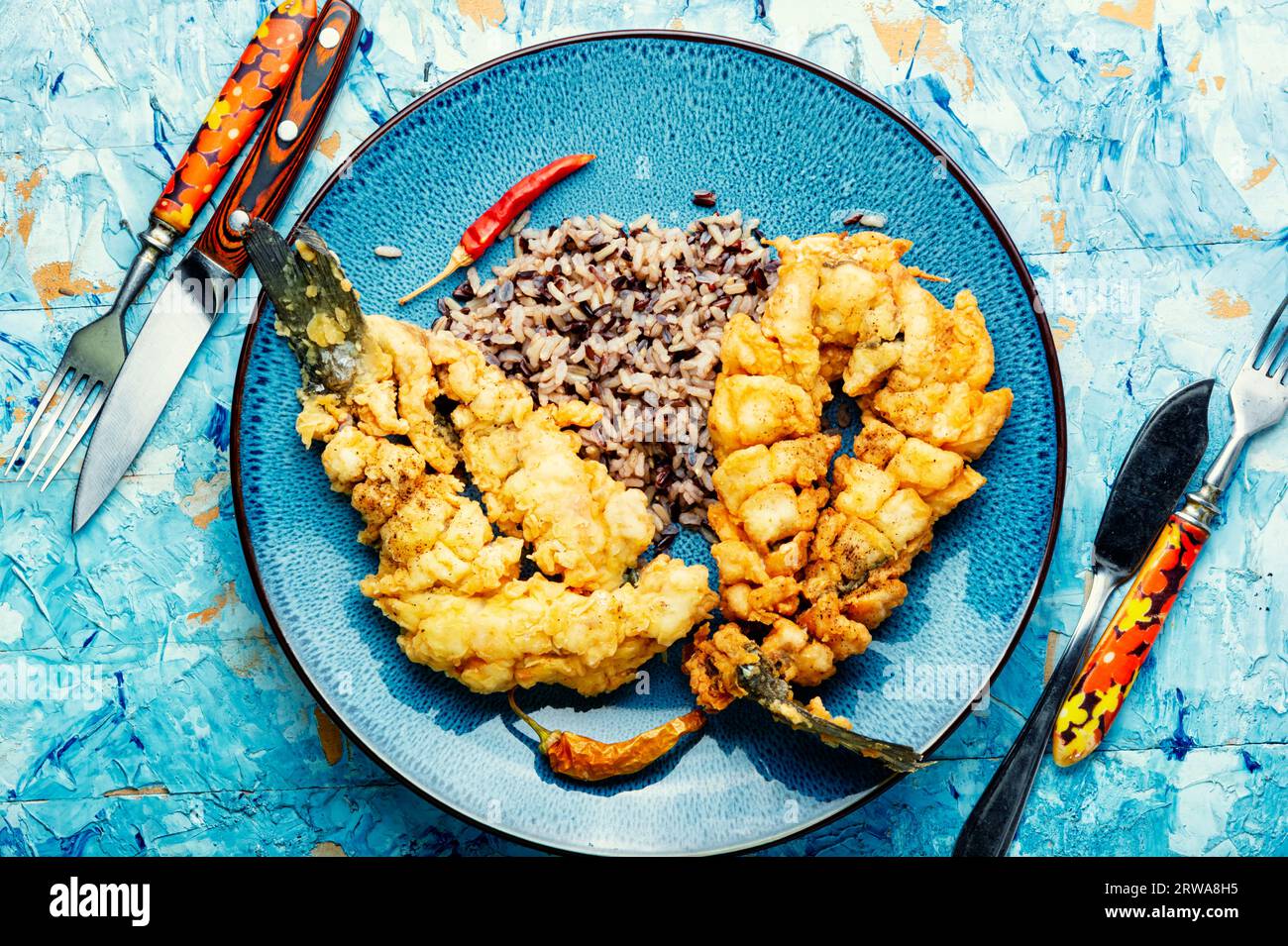 Breaded dietary fish and boiled wild rice. Deep fried fish Stock Photo ...