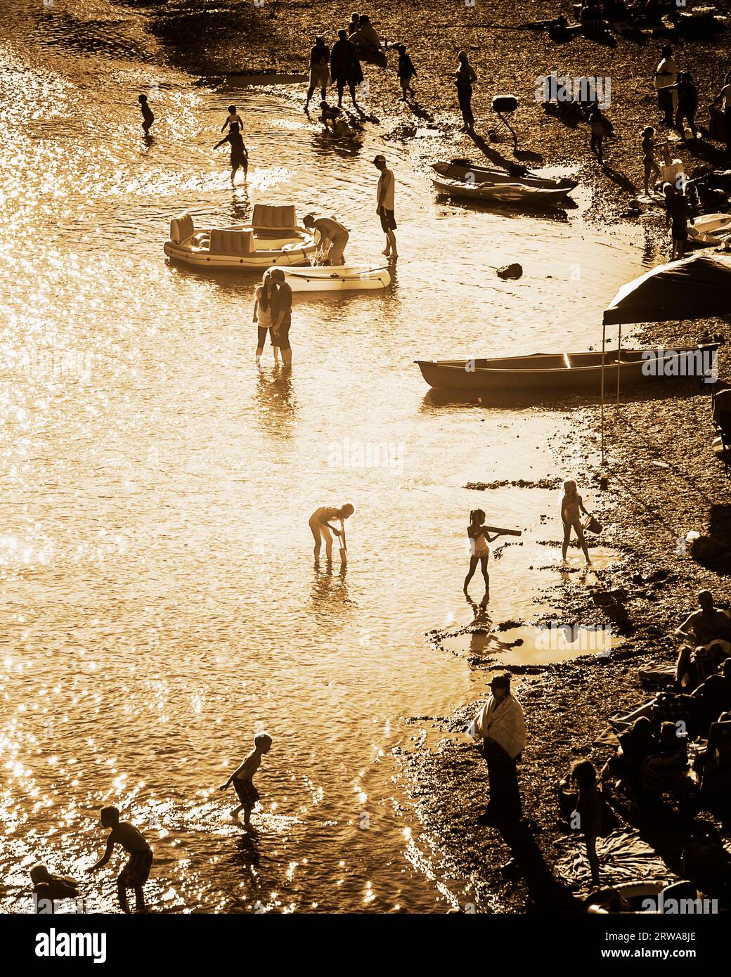 People along the shoreline of a river Stock Photo - Alamy