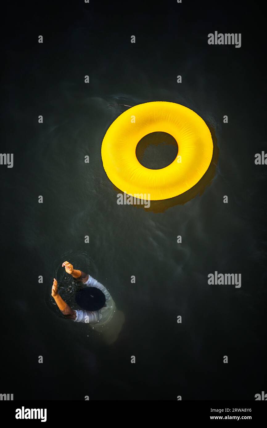 Man and colorful inner tube Stock Photo - Alamy