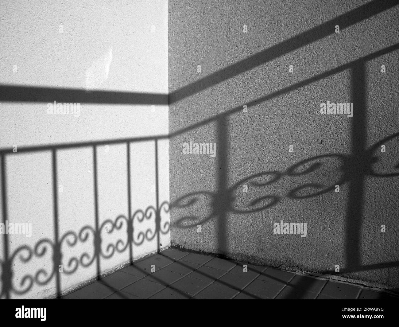 Outdoor view of an outside iron railing. Shadow of decorative metal ...