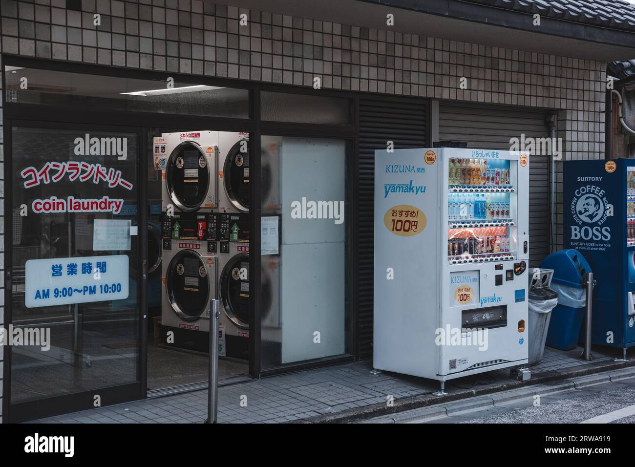 A lively street scene in Japan with a bustling laundry mat and a ...