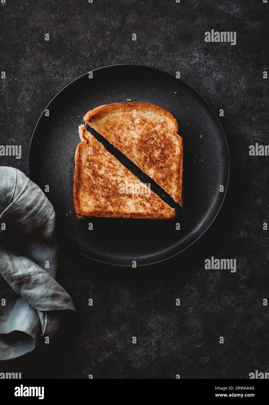 Top view of grilled cheese sandwich on black plate and background Stock ...