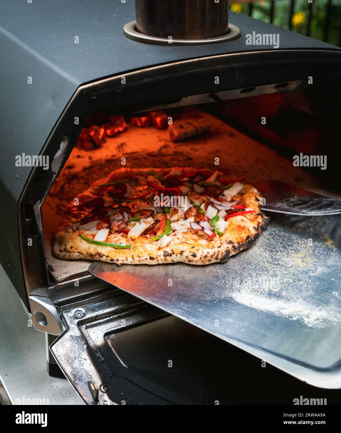 Close up of pizza being cooked outside in a portable pizza oven Stock ...