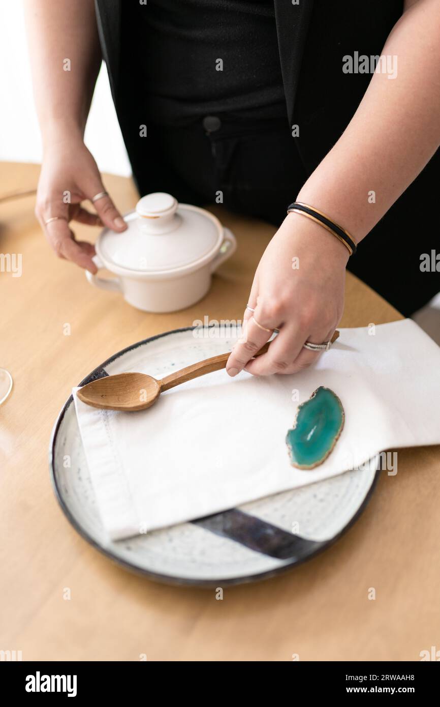 An interior designer styles a modern table setting Stock Photo - Alamy