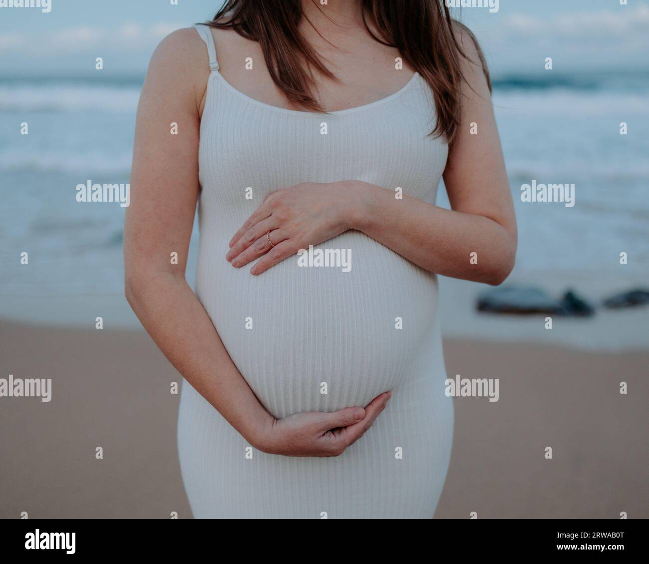 Portrait of pregnant mother in third trimester at beach at sunset Stock ...
