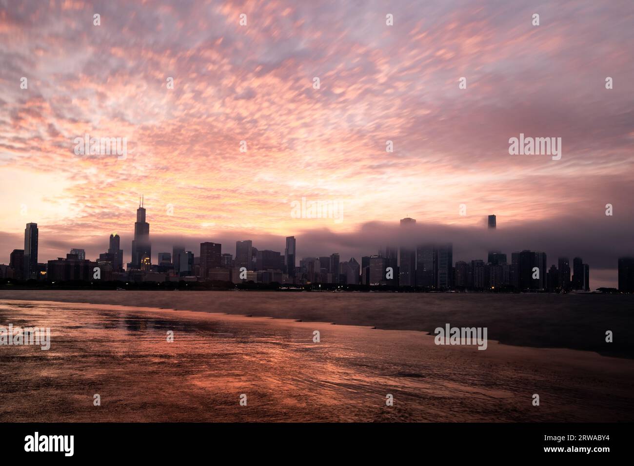 Chicago skyline with dramatic clouds at sunset Stock Photo - Alamy