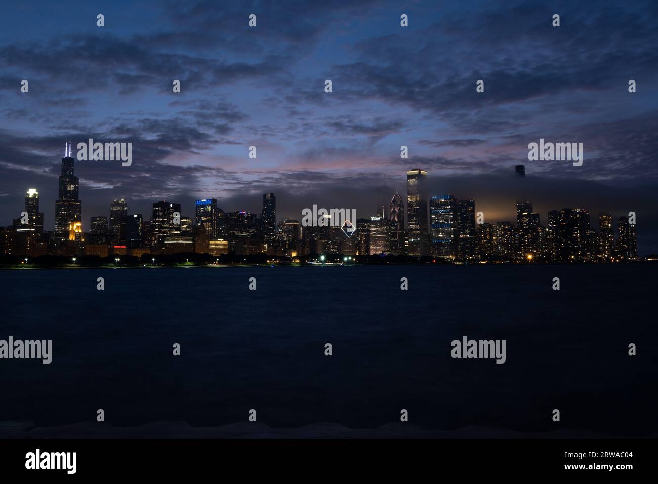 Chicago skyline with dramatic clouds at sunset Stock Photo - Alamy