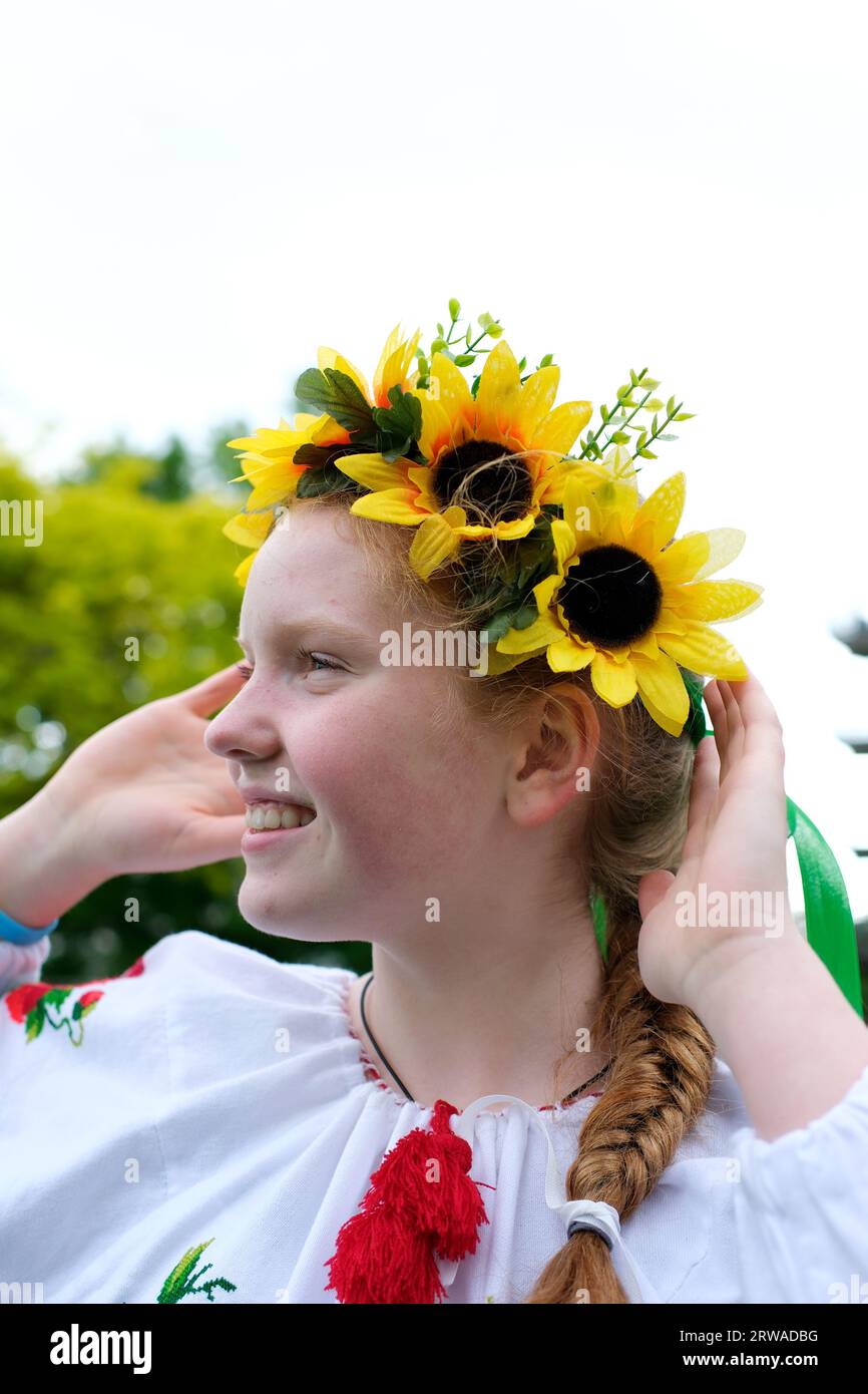beautiful red-haired Ukrainian girl in an embroidered blouse flowers ...