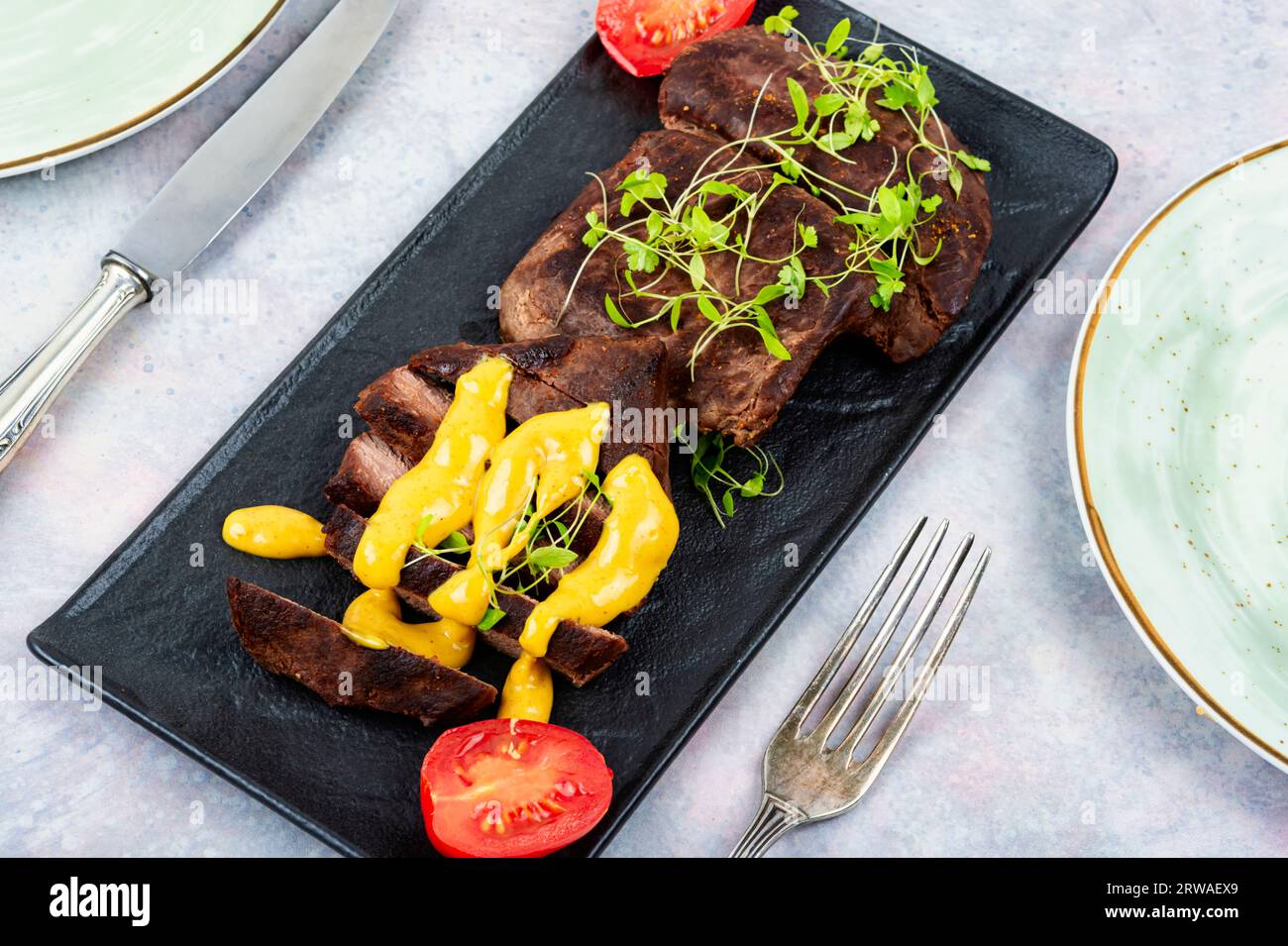 Roasted ostrich meat steaks with sauce. African cuisine Stock Photo - Alamy
