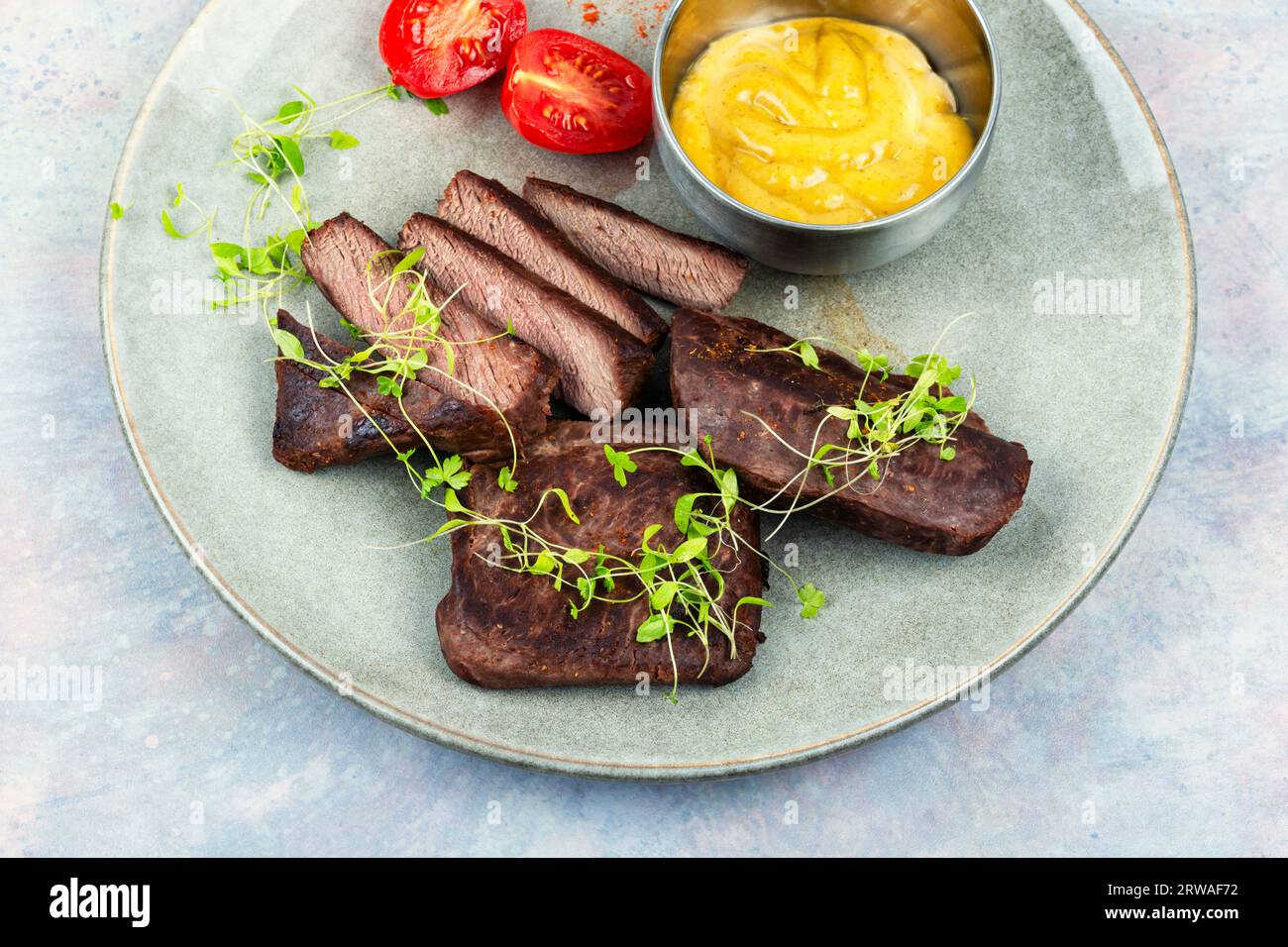 Delicious ostrich meat steaks on the plate. African cuisine Stock Photo ...