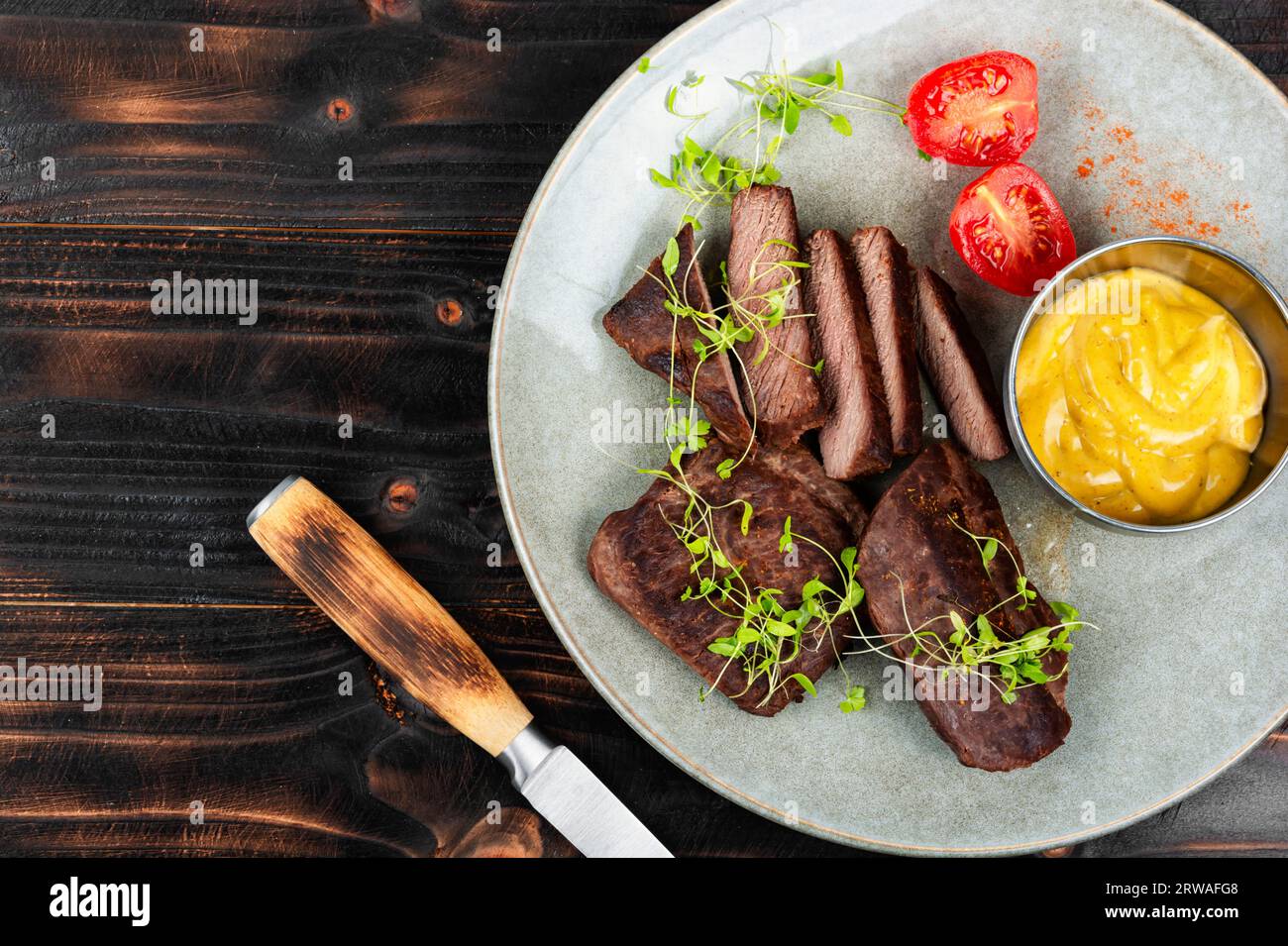 Delicious ostrich meat steaks. Ostrich fillet on black rustic ...