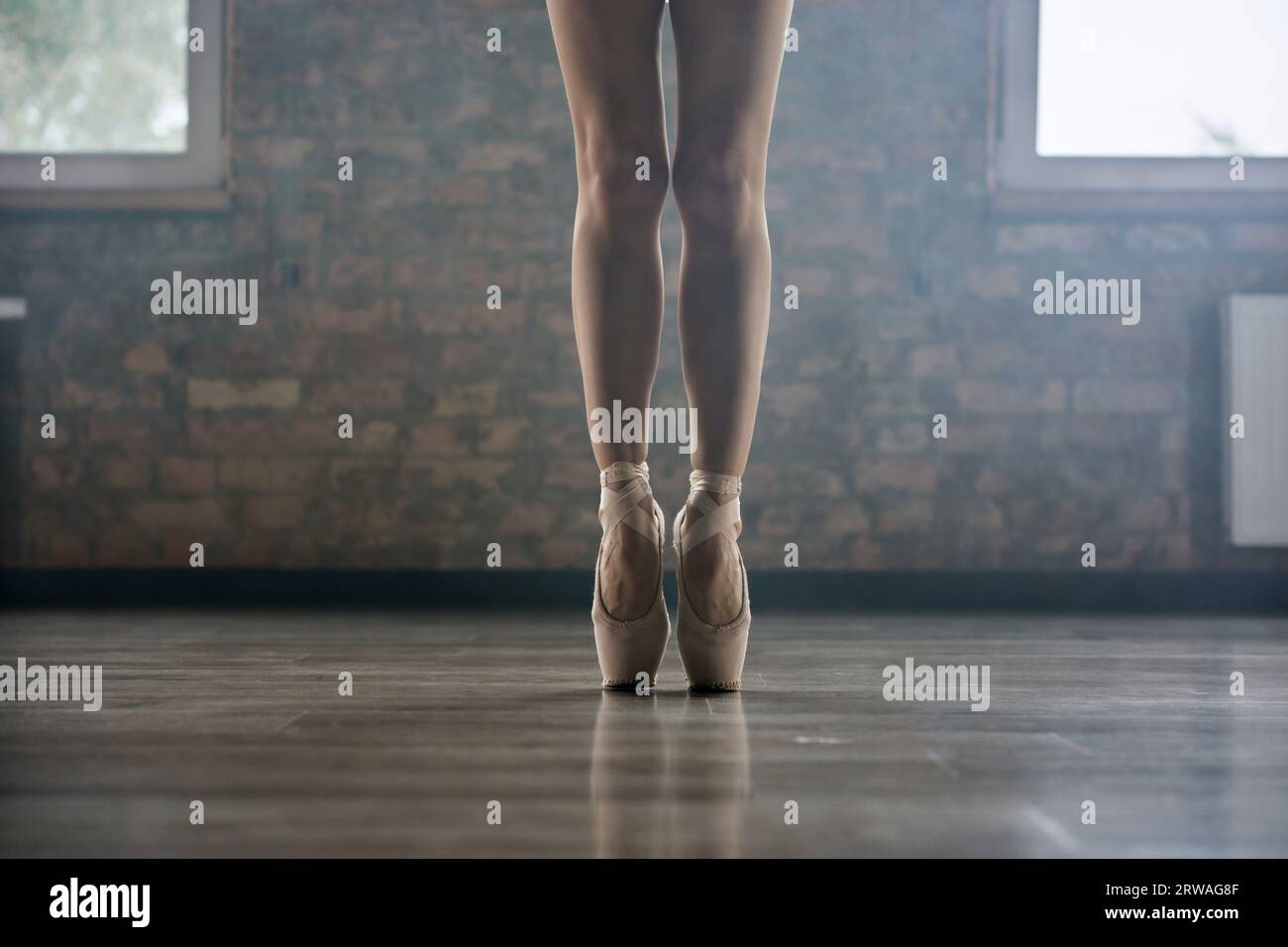 Elegant female ballerina legs in pointe shoes standing on toes at ballet class Stock Photo - Alamy
