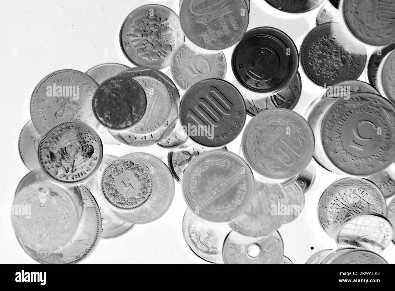 A collection of international coins and currency in a black and white ...