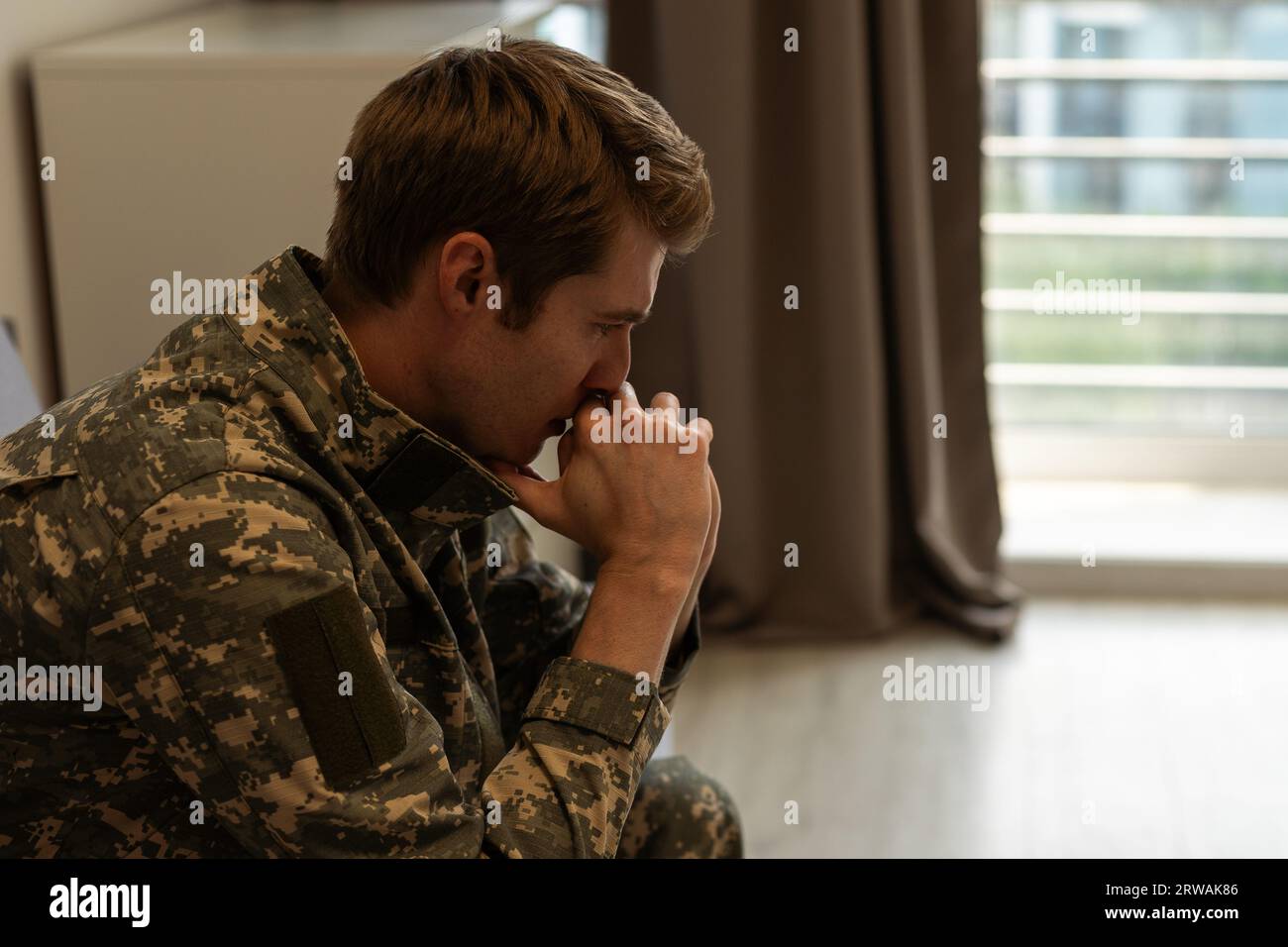 Nervous male military suffering depression, sitting alone at home, PTSD ...