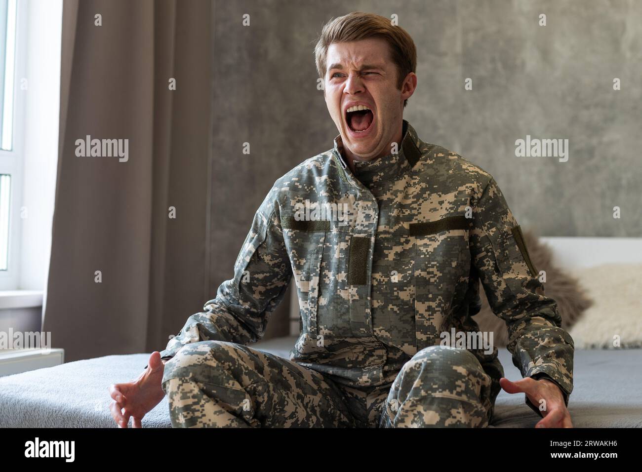Stressed veteran soldier engrossed in depressive thoughts and memories ...