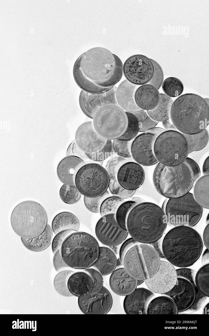 A collection of international coins and currency in a black and white ...