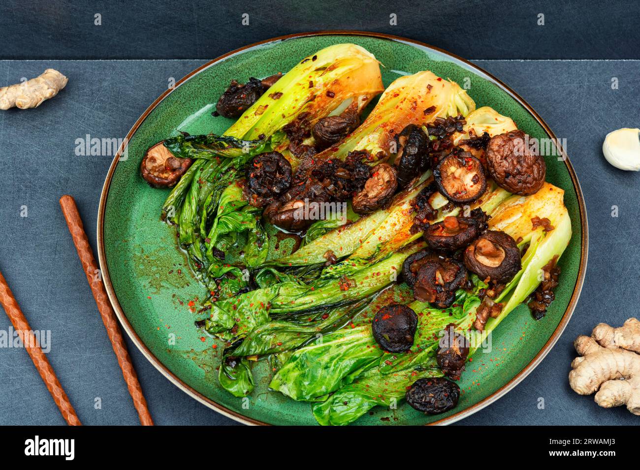Chinese fried Pak Choi with shitake mushrooms and chopstick. Asian ...