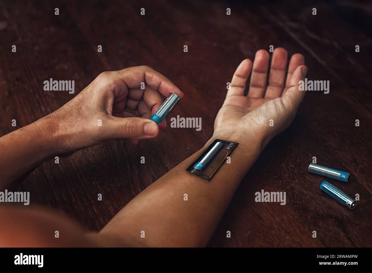 Conceptual image of a tired man recharging his battery Stock Photo - Alamy