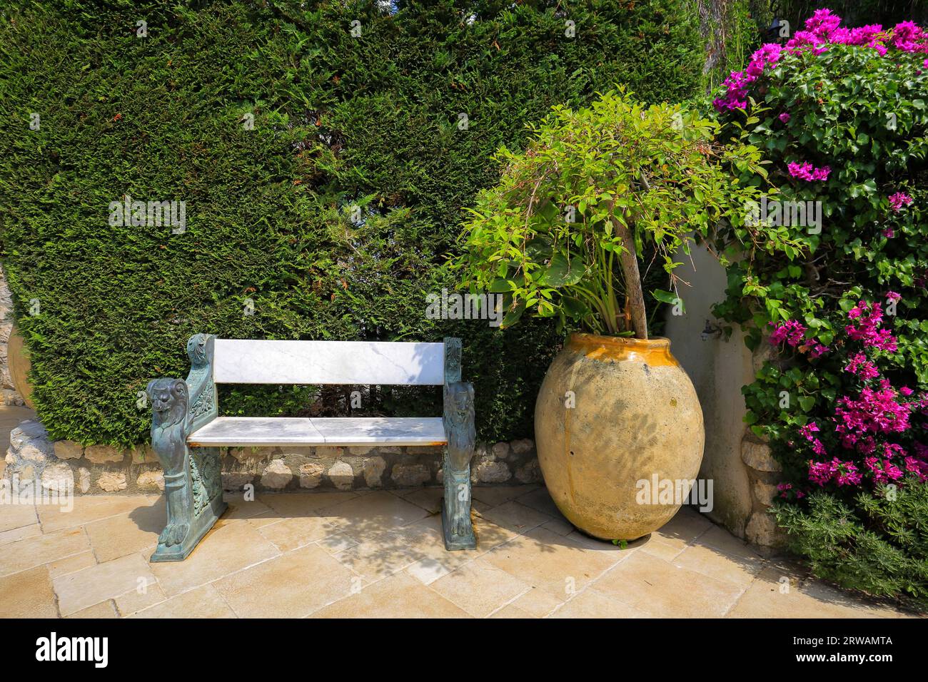 Outdoor bench and big flower pot in Eze, France Stock Photo - Alamy