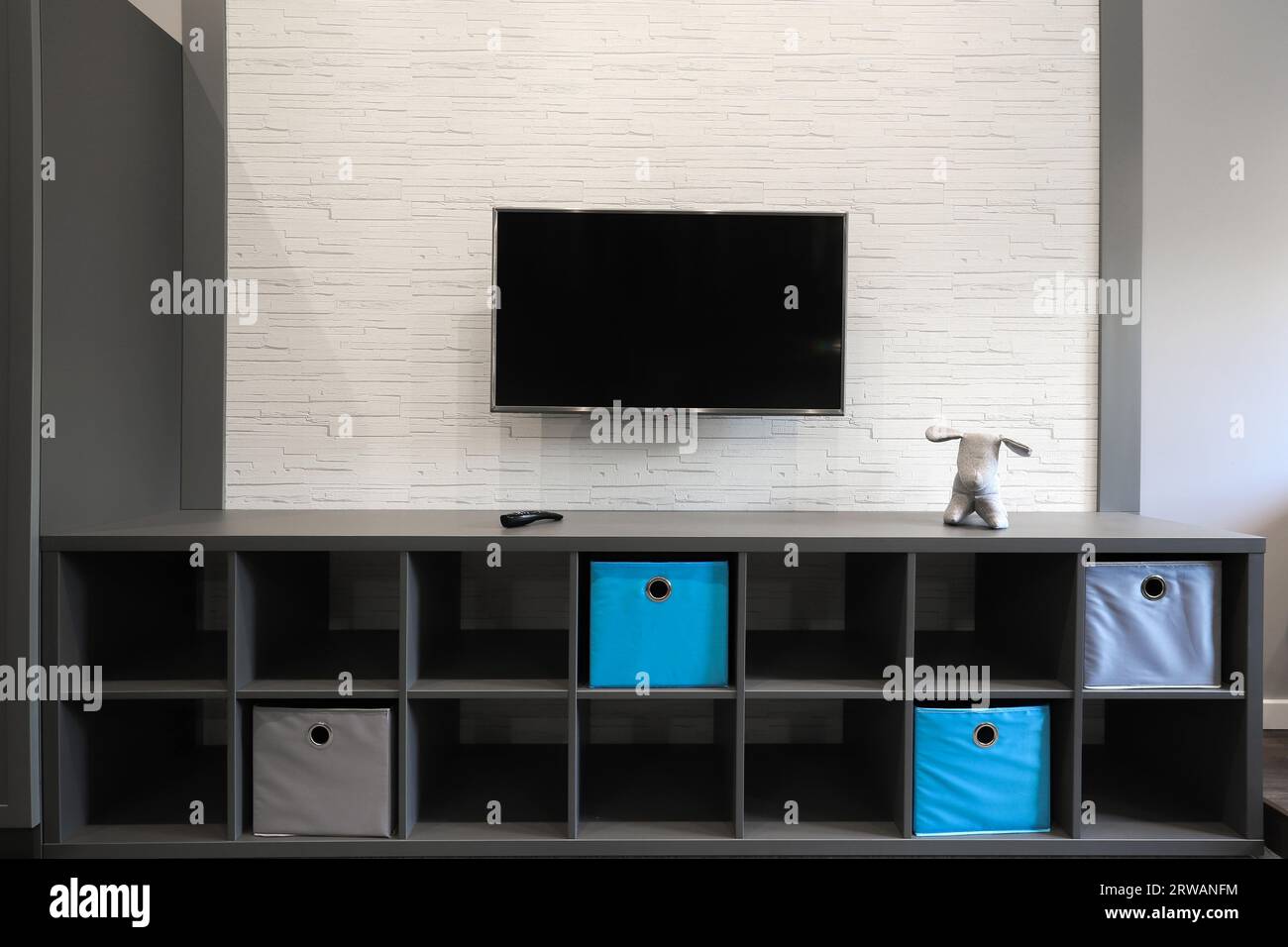 Modern TV hanging on the wall in the living room Stock Photo - Alamy