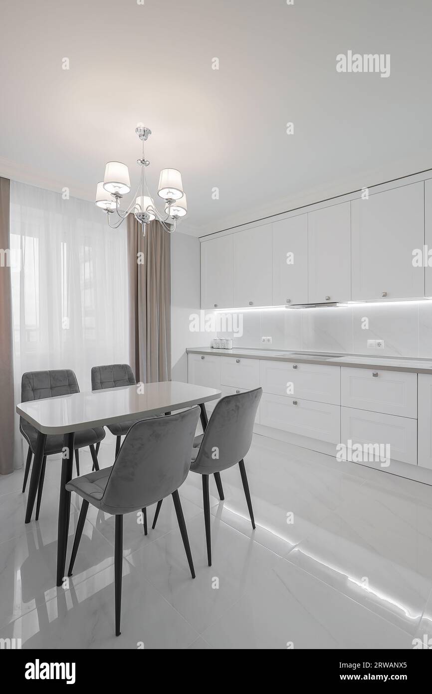 Dining table with chairs in the modern kitchen interior Stock Photo - Alamy