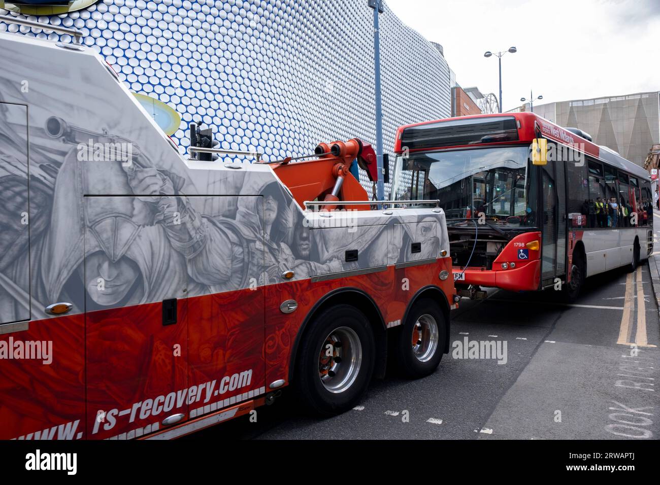 Broken down bus being towed away by a large vehicle recovery truck on ...