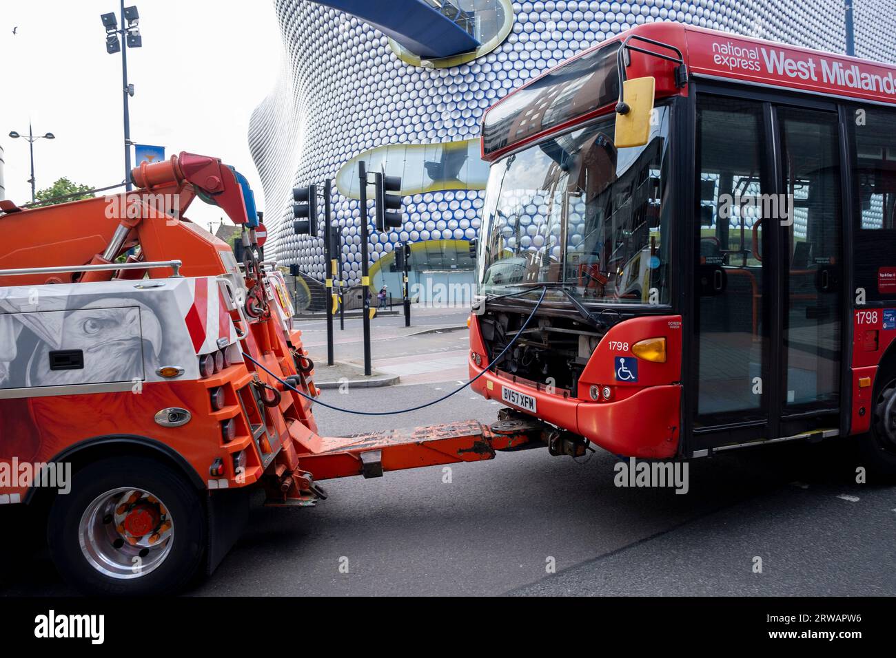 Broken down bus being towed away by a large vehicle recovery truck on ...