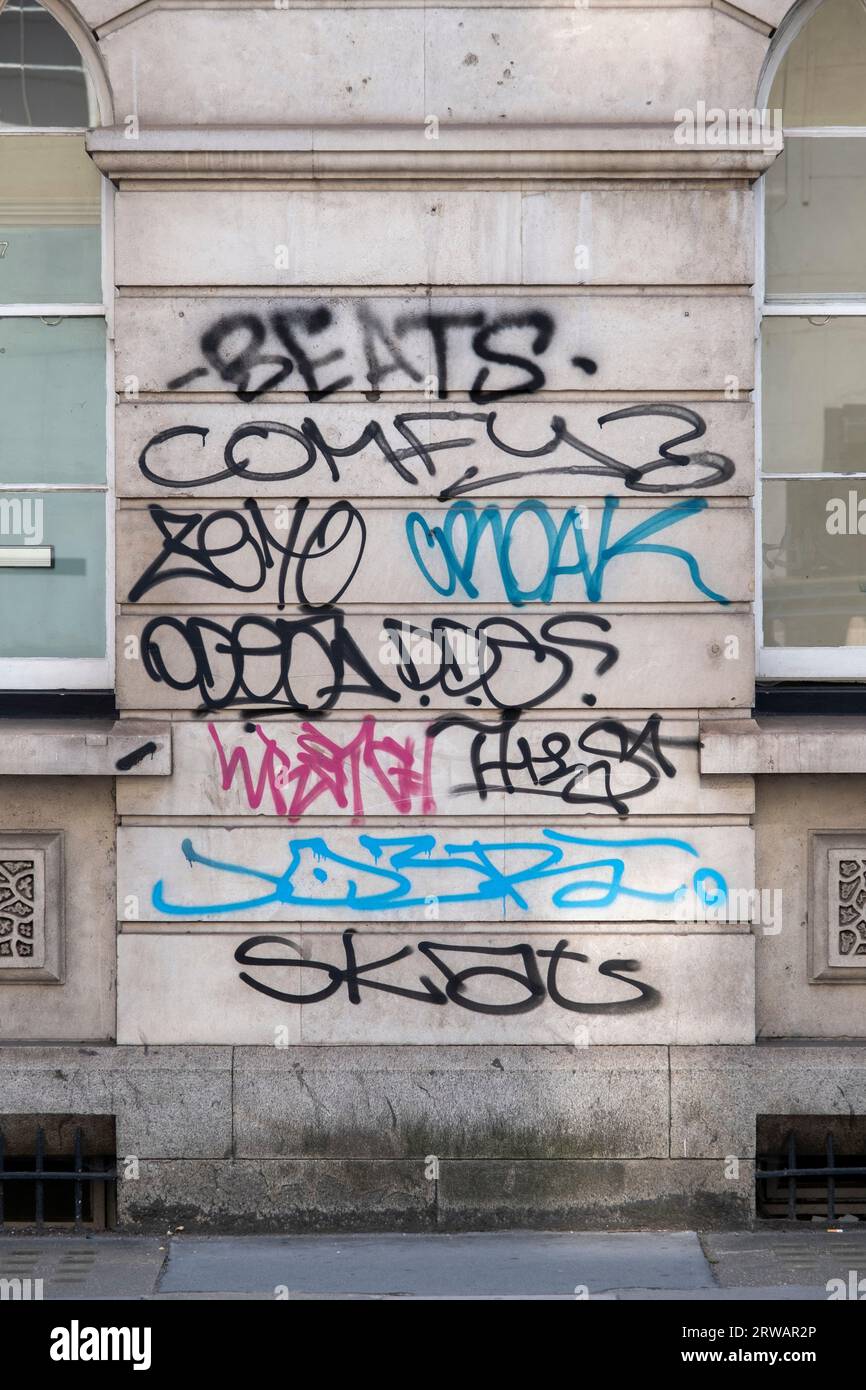 Graffiti and tags covering a wall in Spitalfields on 16th August 2023 ...