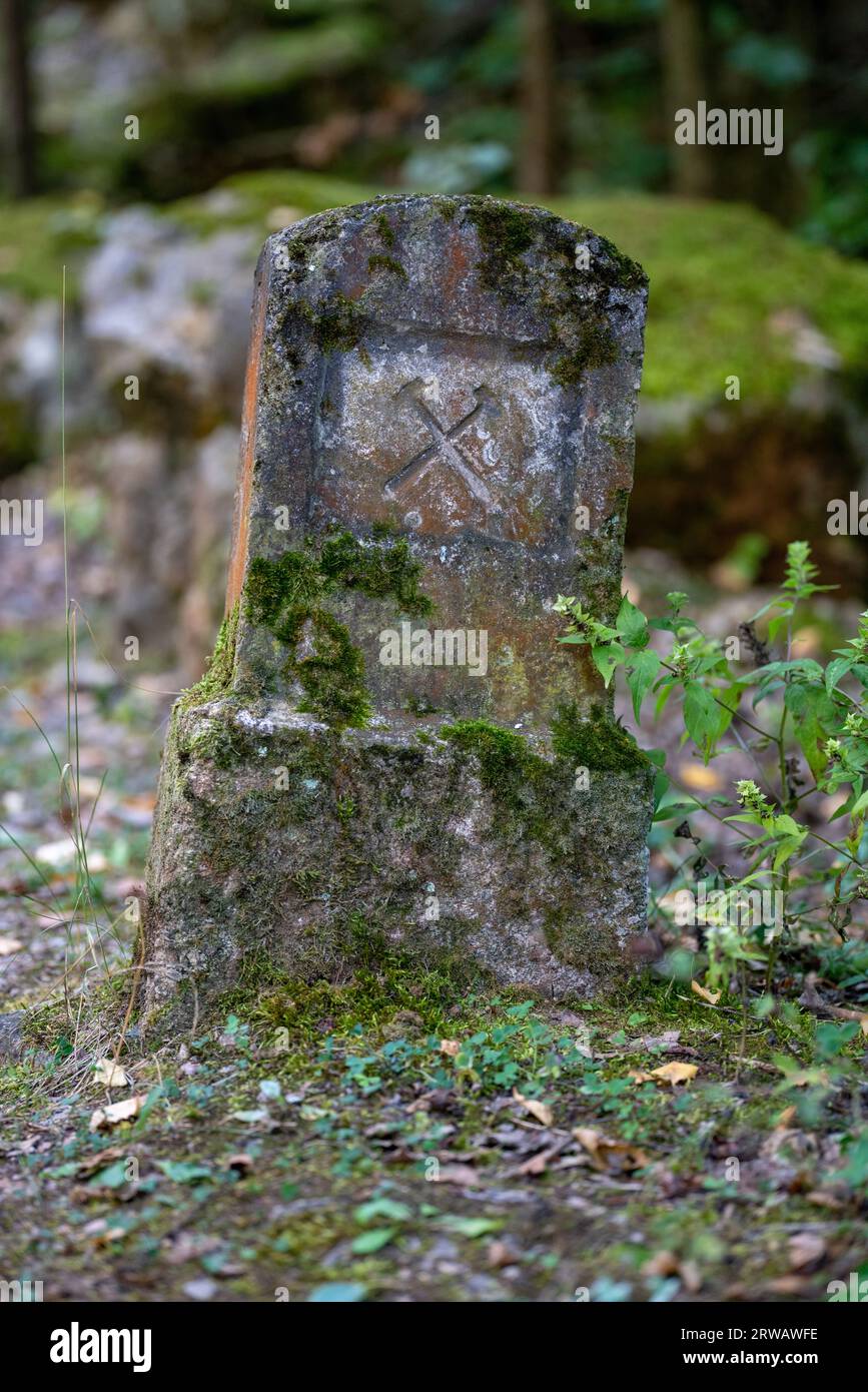 A stone marker with the mining symbol of hammer and pick in the area of ...