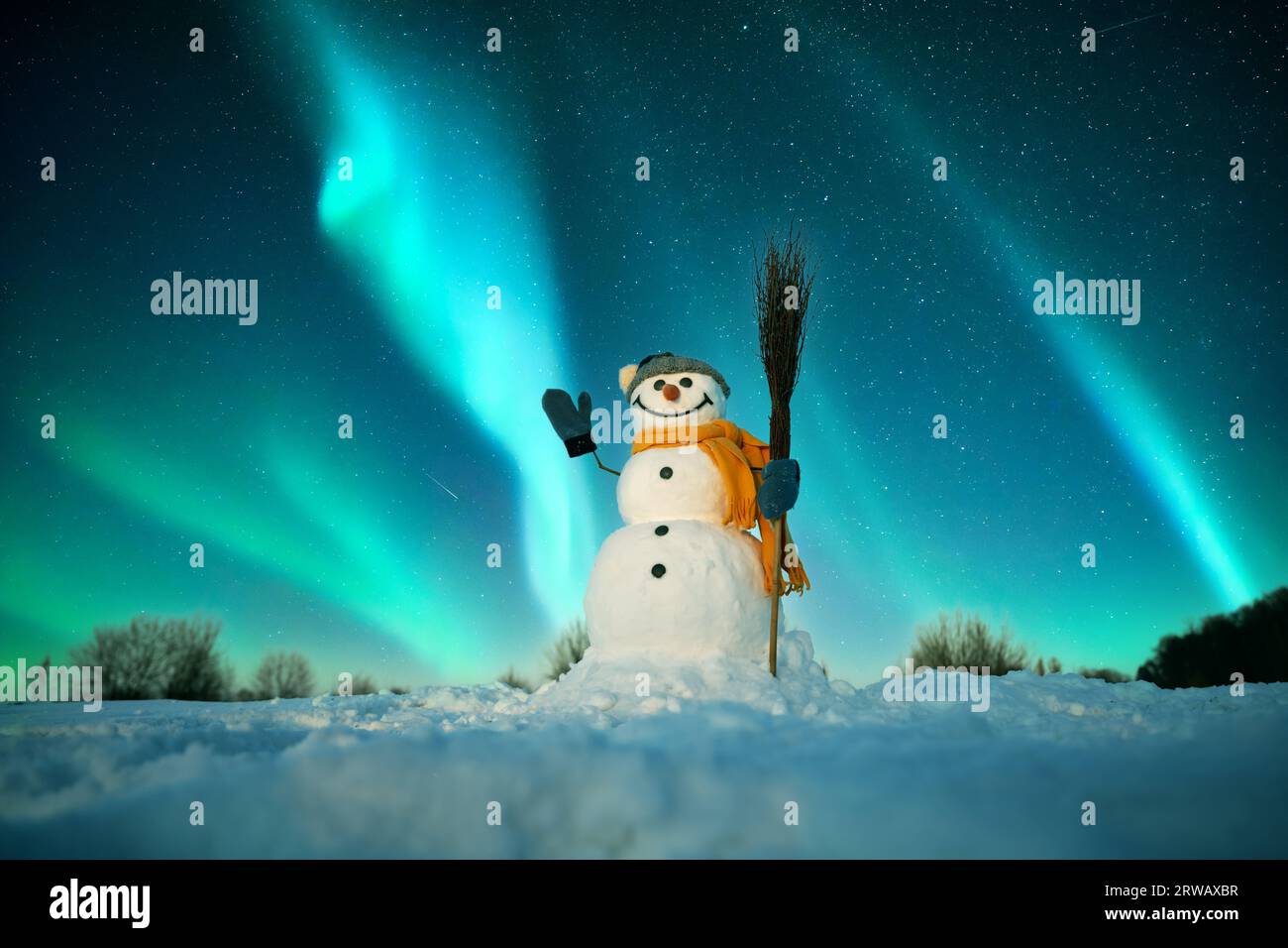 Funny snowman in stylish red hat and red scalf on snowy field against ...