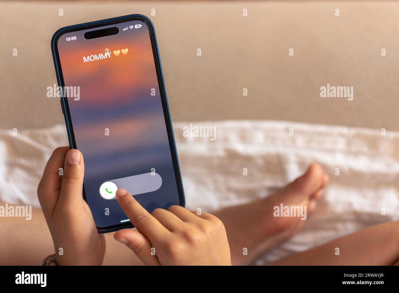 Smartphone in child hands with Incoming Mommy call on a screen Stock ...