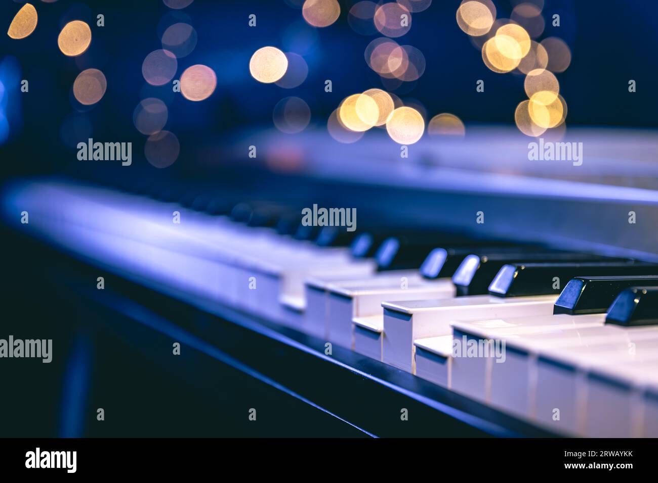 Piano keys close-up on a blurred background with bokeh Stock Photo - Alamy
