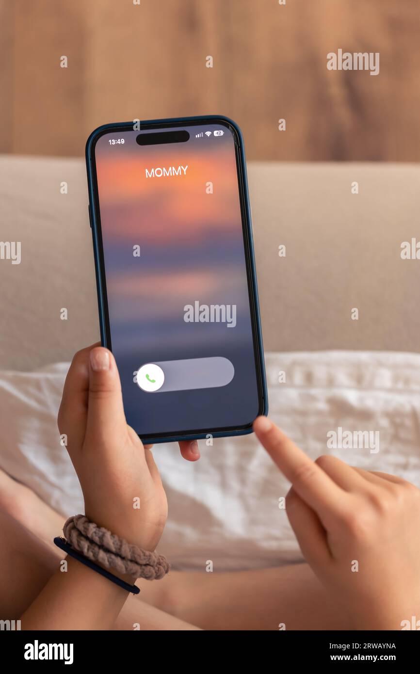 Smartphone in child hands with Incoming mommy call on a screen Stock ...