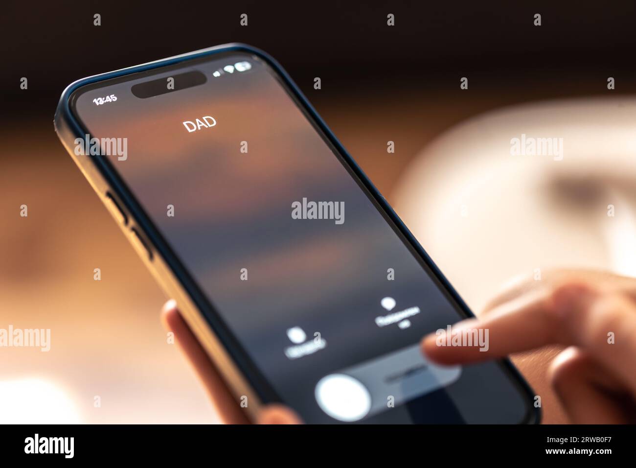 Close up of child hands holding phone with Dad's incoming call on ...