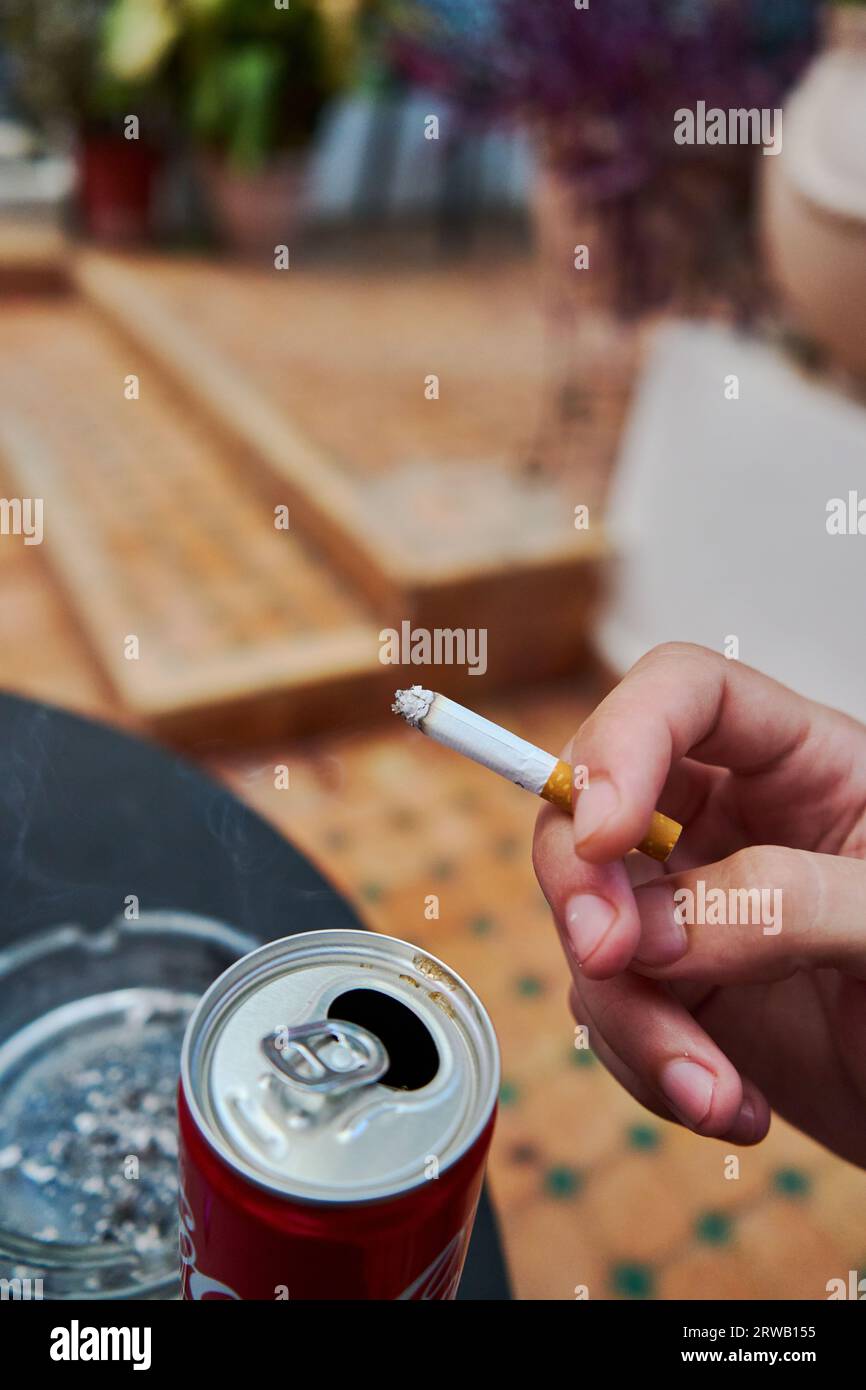 person with cigarette in hand Stock Photo - Alamy