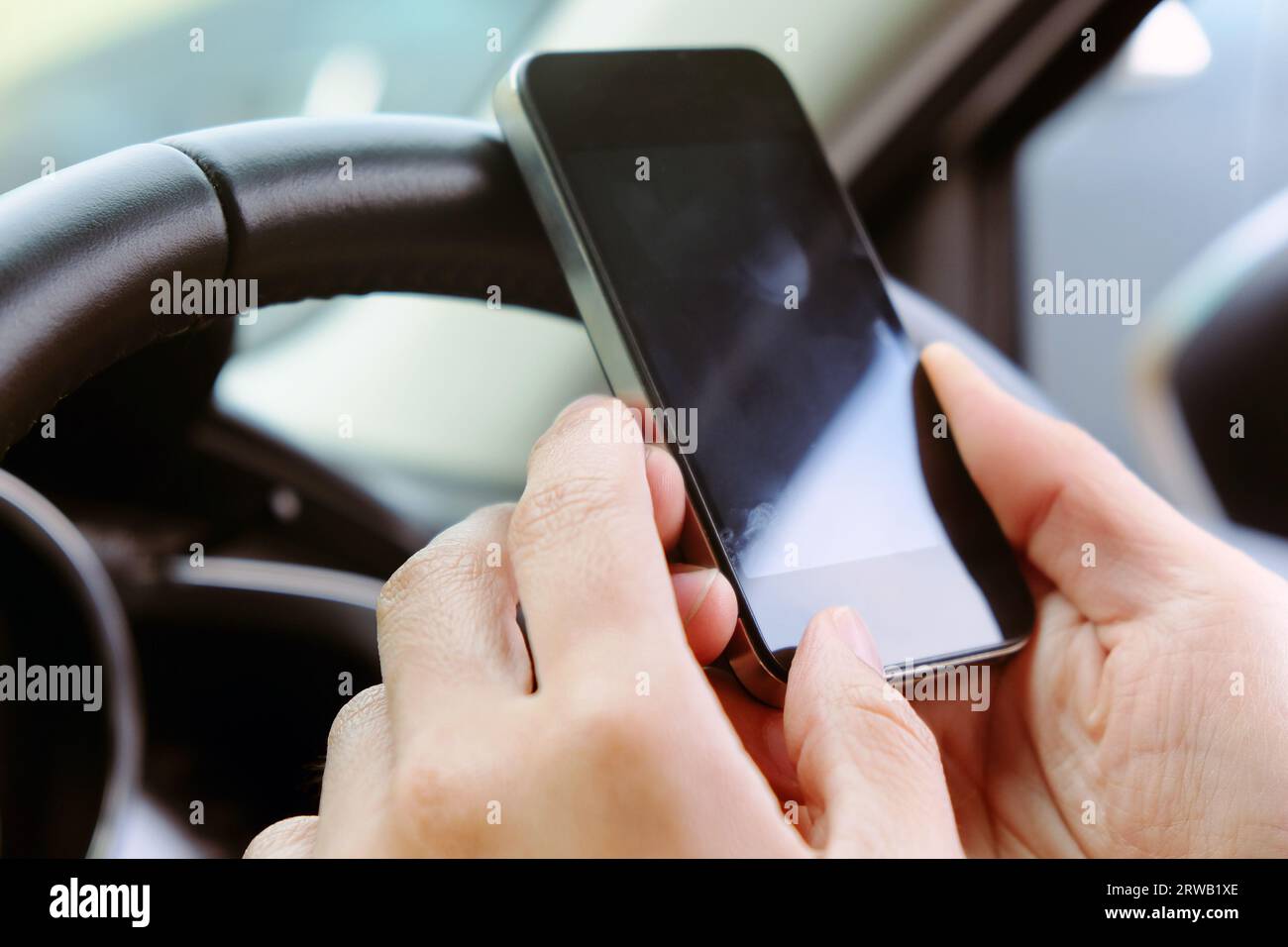 image of using a mobile phone inside of a car Stock Photo - Alamy