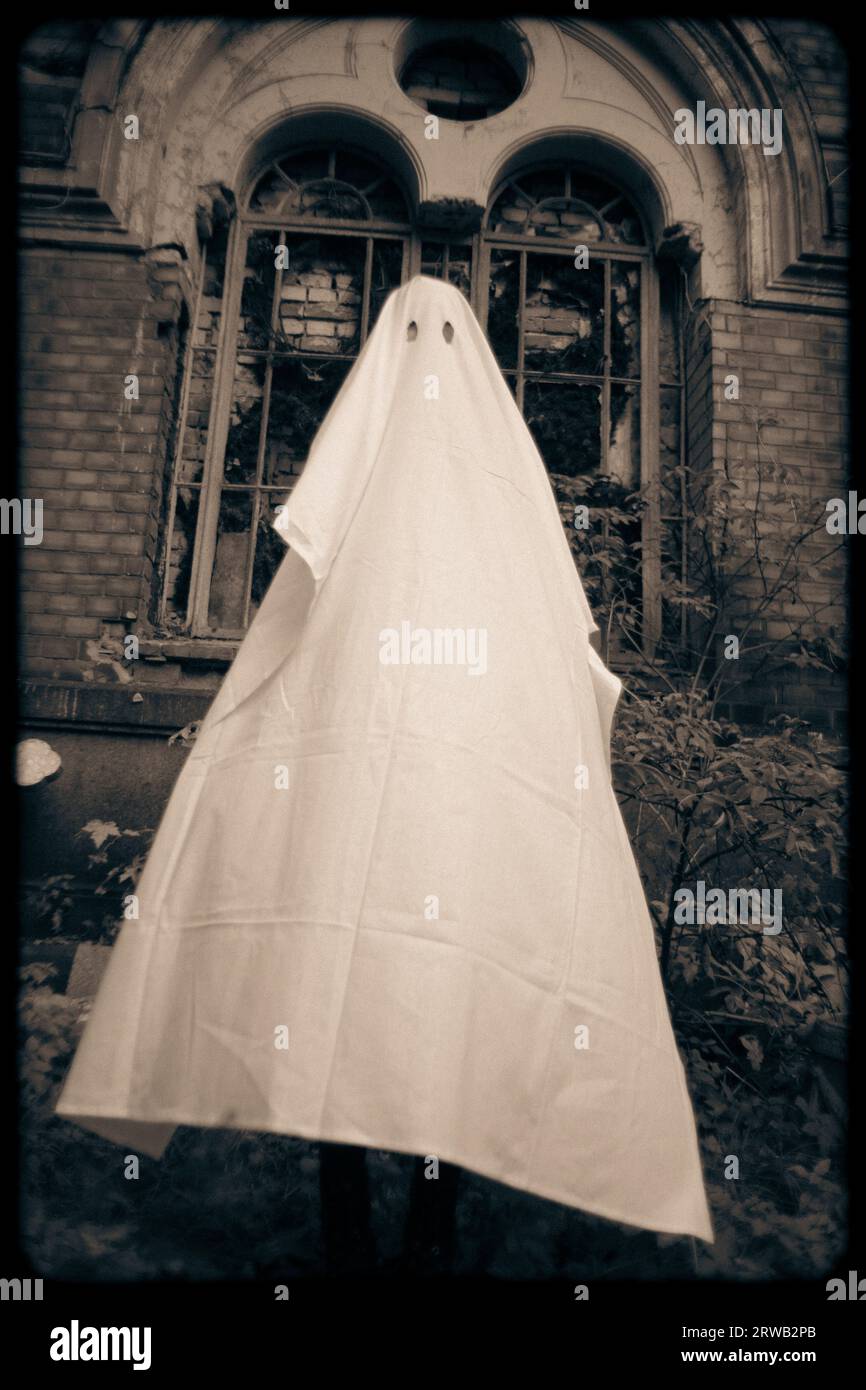 A ghostly figure stands against the backdrop of an old mausoleum on a ...